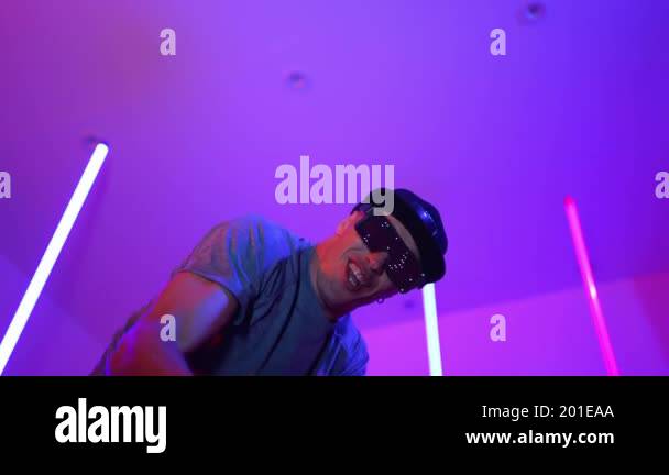 Low angle camera of caucasian dancer wearing fancy glasses and ...