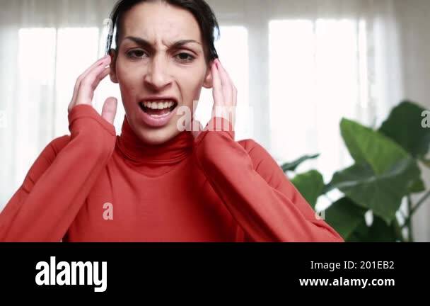 Young woman expressing intense frustration and anger while screaming ...