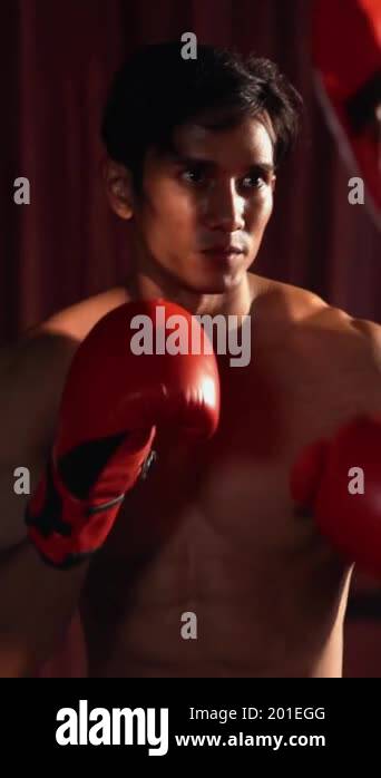 Asian and Caucasian Muay Thai boxer unleash punch in fierce boxing ...