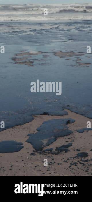 Oil in ocean coastline after a tanker wreck. Oil fuel polluted and ...