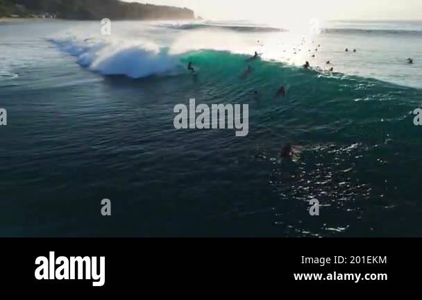 Surfers on surfboard riding on perfect barrel wave. Surfing on perfect ...