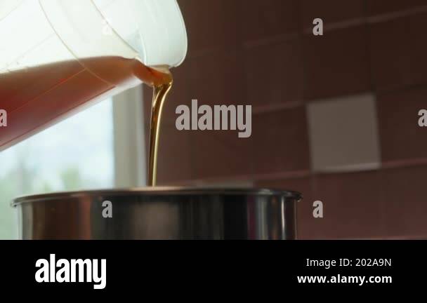Closeup of unrecognizable pastry chef pouring syrup from plastic ...