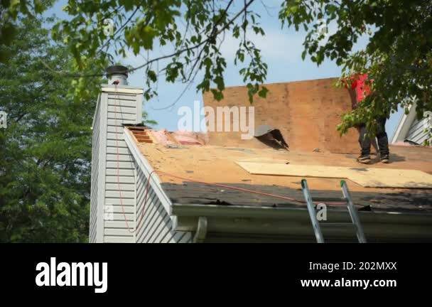 Roofers repair a roof on an house. Work moments. High quality 4k ...