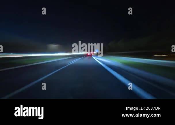 Speedy car driving the highway with a lot of lights and traffic ...