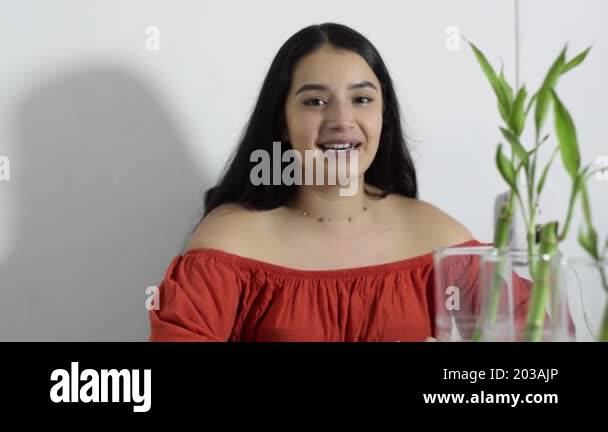 Beautiful latina woman talking in front of the camera and laughing a ...