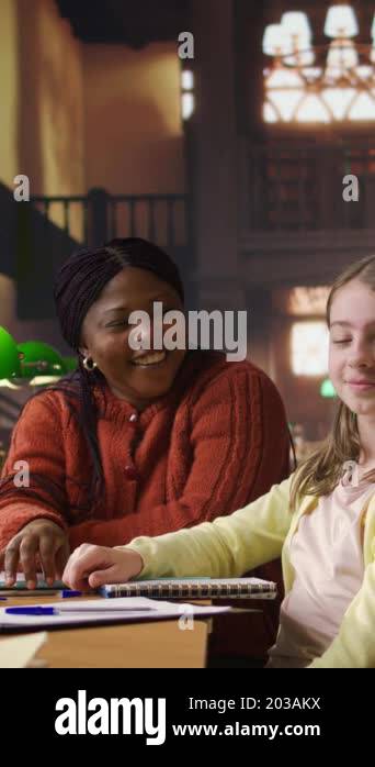 Vertical Video Elementary school pupils working with a professor ...