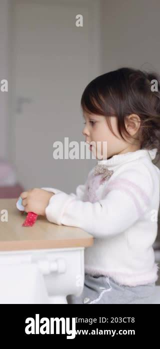 cute little child girl gluing paper garlands and preparing for ...