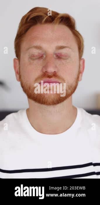 Vertical video. Close up POV man listening colleague on laptop video ...