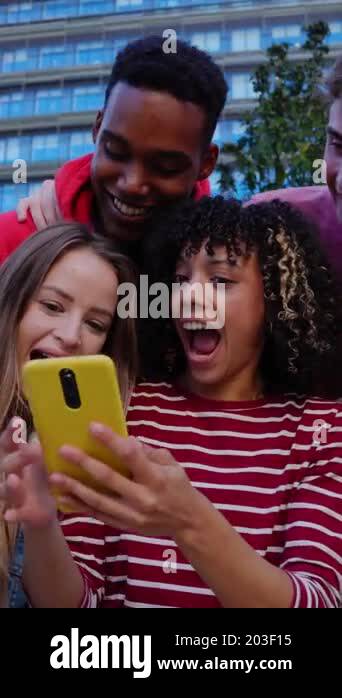 Vertical HD video of young Gen Z group of diverse friends having fun ...