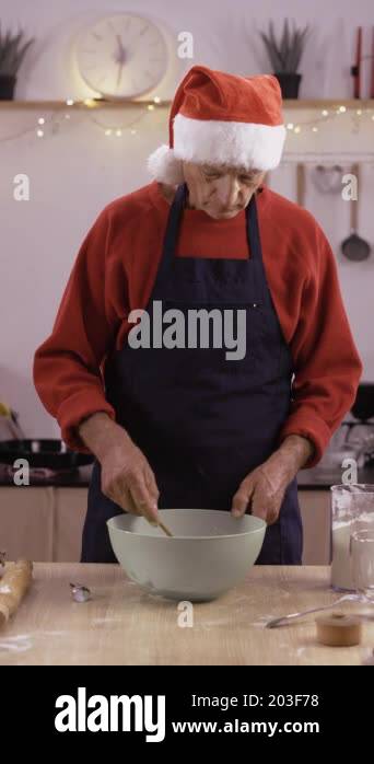 Elderly senior man making dough for christmas gingerbread cookies ...
