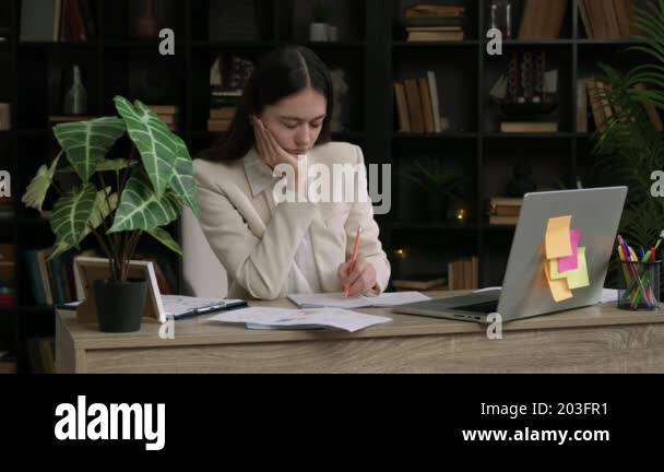 Young woman manager suffers from headache at workplace with laptop in ...