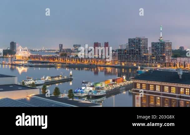 Aerial view over towers in Maashaven night to day transition timelapse ...