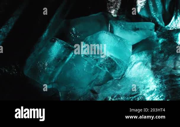 Ice cubes melting on reflective surface. Frosty texture. Macro video ...