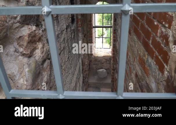 A narrow medieval passageway with ancient brick and stone masonry ...