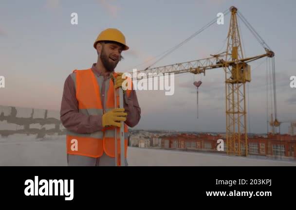 Funny construction worker dancing. Positive dance of builders in helmet ...
