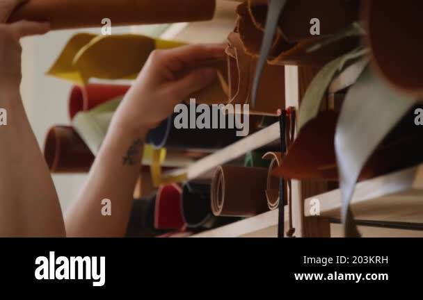 Close-up shot of master craftsman sorting out material in wooden ...