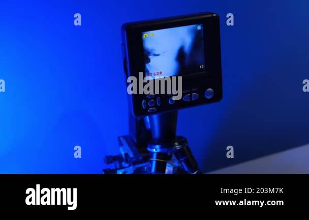 Close-up of a digital microscope with a display screen showing fast ...