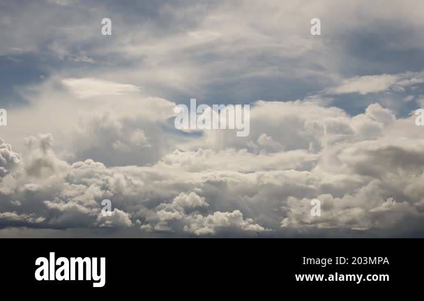 Clear blue sky with cumulus clouds that stand still and cirrus clouds ...