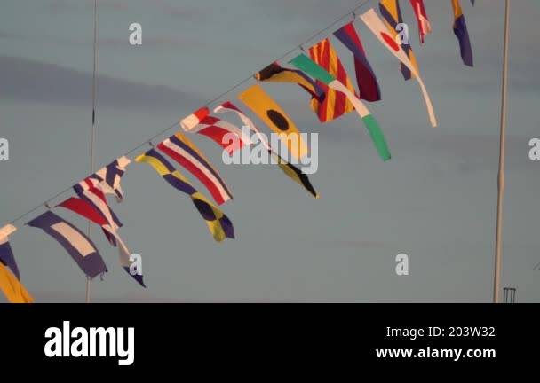 Various nautical flags tied together with rope, Ship flags signals ...
