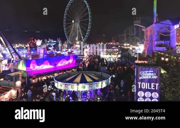 Nighttime scene of a London Christmas fair with vibrant lights, a ...
