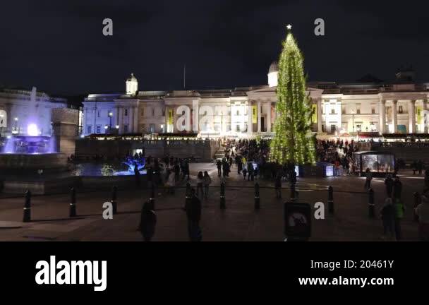 Trafalgar Square in London features a large Christmas tree, colorful ...