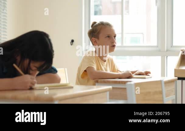 Smart student answer teachers question while sitting at classroom ...