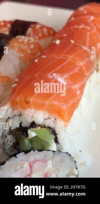 Variety of sushi rolls and nigiri on plate, traditional Japanese ...