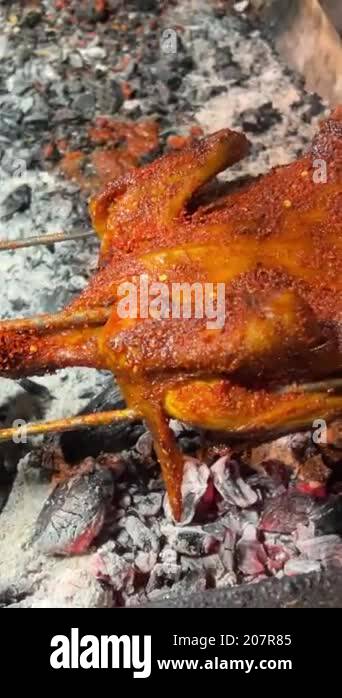 Roasted chicken on spit turning in BBQ. High quality 4k footage Stock ...
