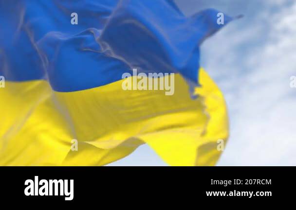 Close-up of Ukraine national flag waving on a clear day. Two horizontal ...