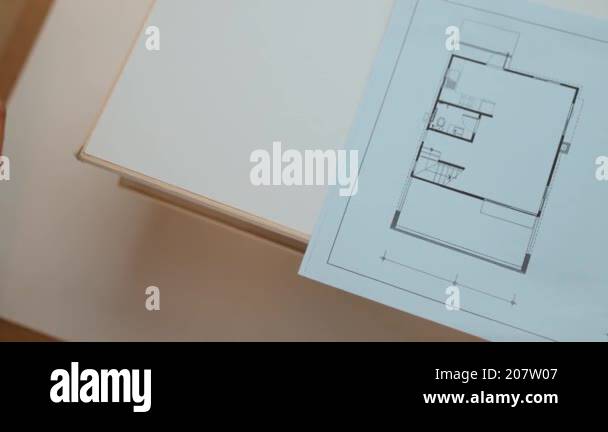 Interior designer drafting blueprint with customer supervise and ...