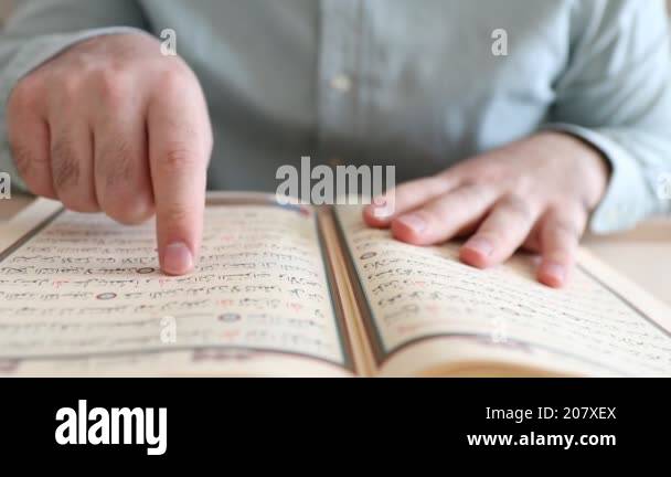 Close up of a person reading the Quran Stock Video Footage - Alamy