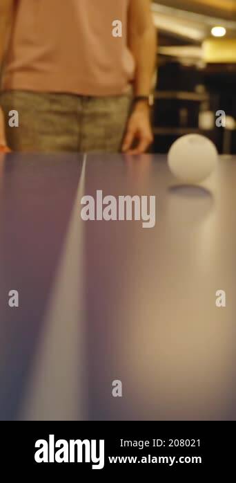 Vertical video. A slow-motion low-angle view of a person preparing to ...