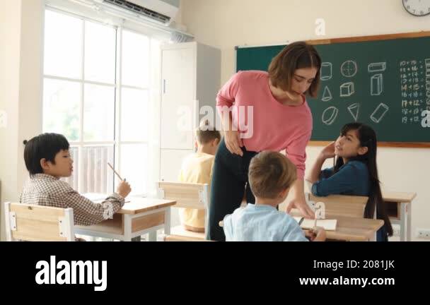 Smart asian student raised hand and asking teacher about math question ...