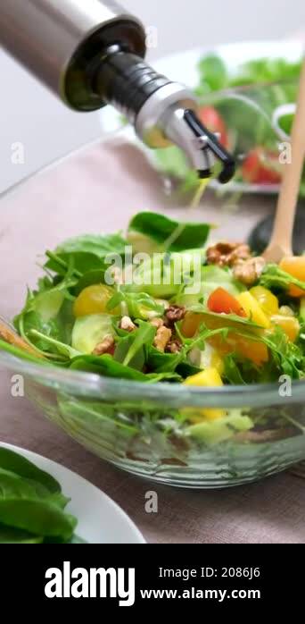 Couple cooking in the kitchen. womans hand preparing salad for dinner ...