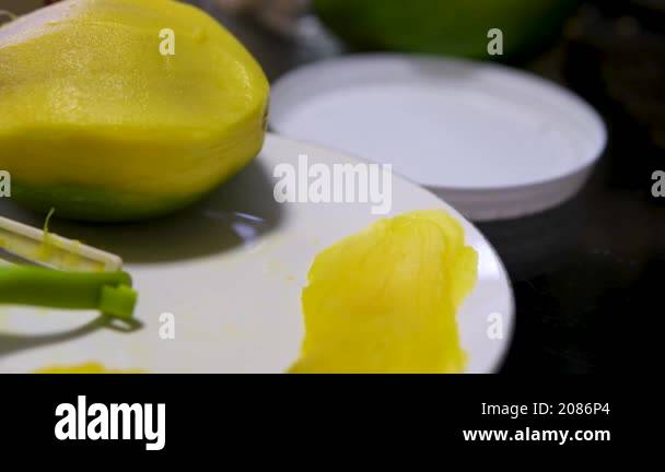 Close-up of a young woman holding a cut rotten mango. Completely rotten ...