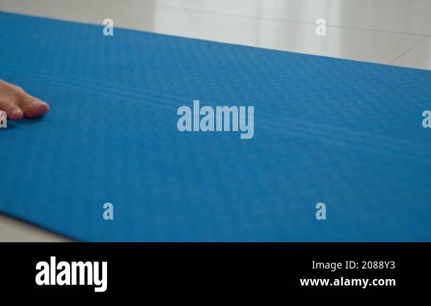 Close up female legs feet barefoot on yoga mat gymnastics class gym ...