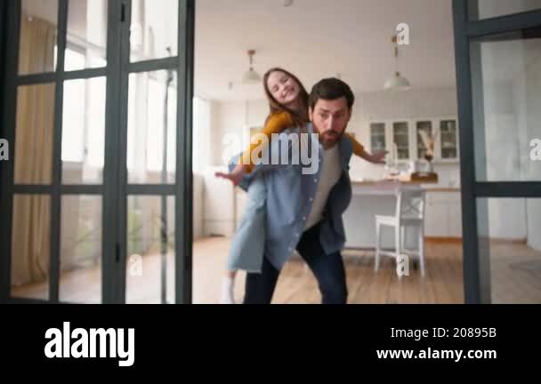 Carefree playful Caucasian daddy man father parent holding daughter ...