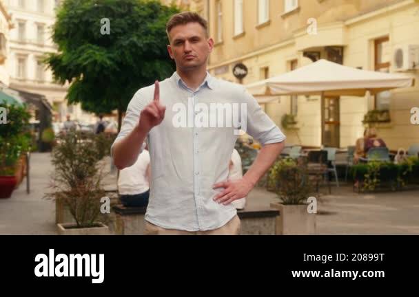 Confident man Caucasian business guy in city serious looking at camera ...