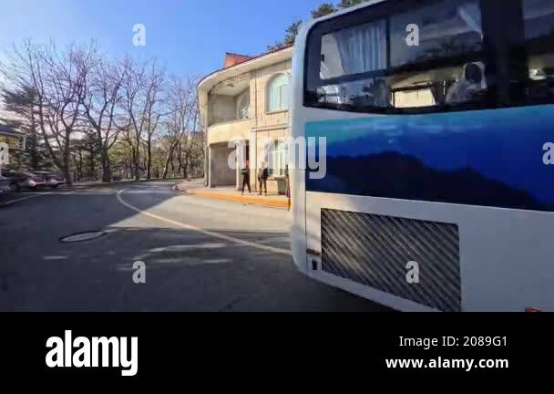A bus makes its way through a narrow street flanked by impressive ...