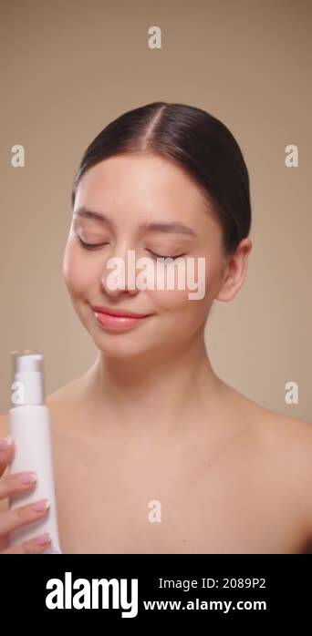 Beautiful woman with bottle of moisturizer cream. Video of woman with ...