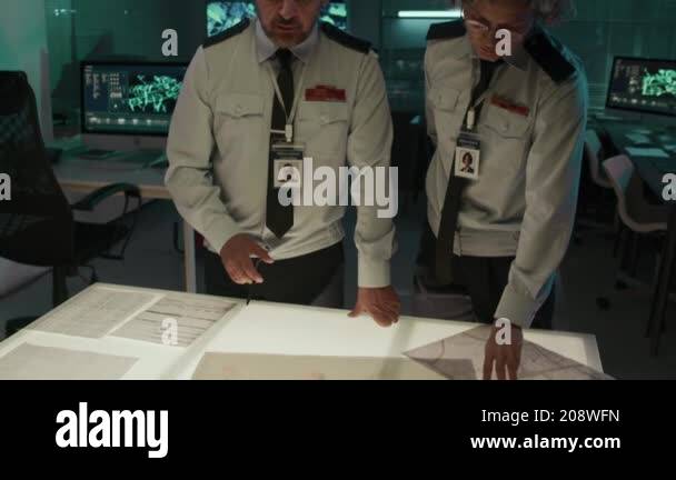 Tilt-down medium closeup of male and female Caucasian military officers ...