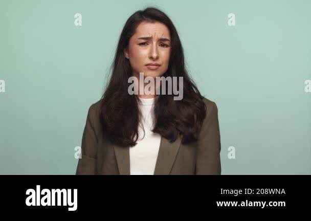 Perplexed young woman showing a why did you do this gesture, conveying ...