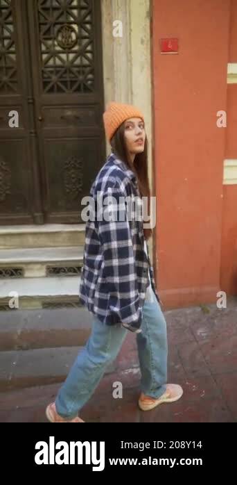 A fashionable person walks confidently in trendy streetwear, showcasing ...