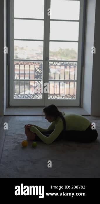 A peaceful and serene yoga session featuring a person gently stretching ...