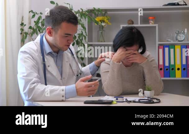 A young doctor in the office, receives a middle-aged woman, disabled ...