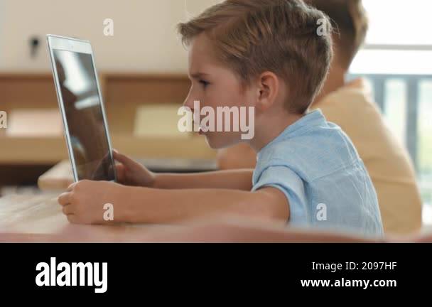 Side view of caucasian boy working on laptop while coding engineering prompt. Attractive ...