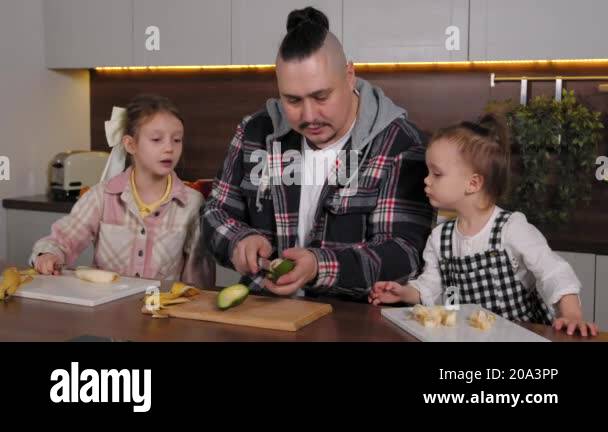 Caring affectionate father showing and explaining to engrossed adorable ...