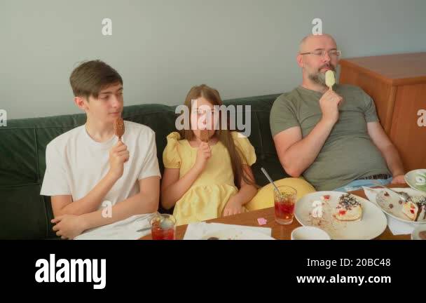Happy family eating ice cream and enjoying time together. Man boy and ...