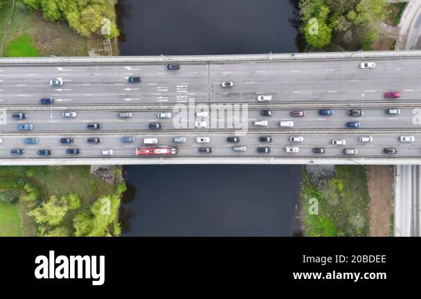 Aerial view of a busy highway bridge over a river with multiple lanes of traffic Stock Video ...