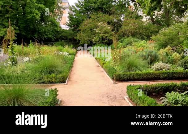 A path, forked road, crossroads in a spring botanical formal garden ...